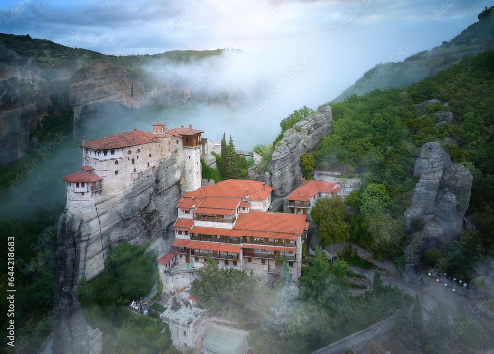 Meteora Monastery of Roussanou rising out of the mist. Aerial, mystical ...