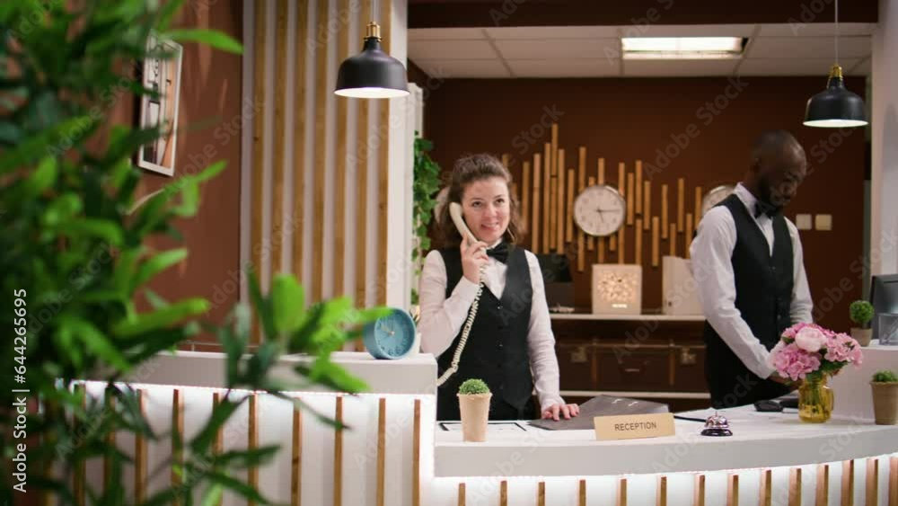 Worker does online reservation requests on telephone call with clients ...