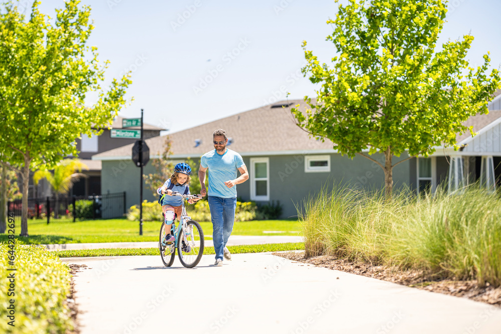 father and son on bicycle at fathers day. active father setting a ...