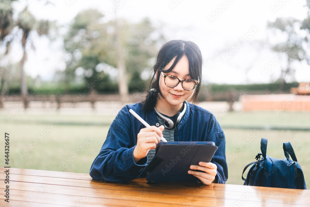 Young adult asian woman using digital tablet for digital nomad work and study Stock Photo ...