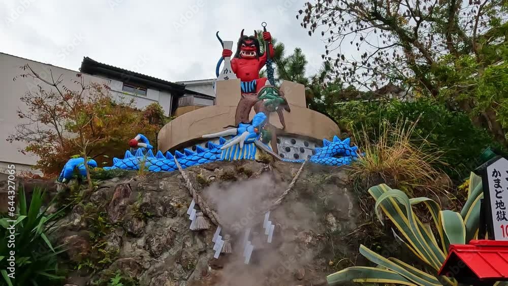 Red demon statue at Kamado Jigoku hot spring in Beppu, Oita. The town ...