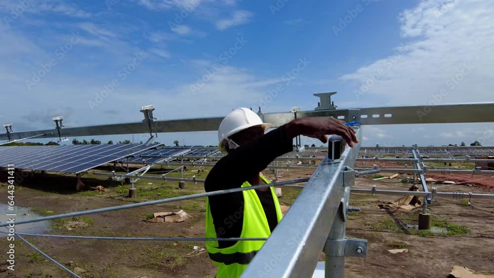 Black Gambian African male engineer man taking solar energy farm panel ...