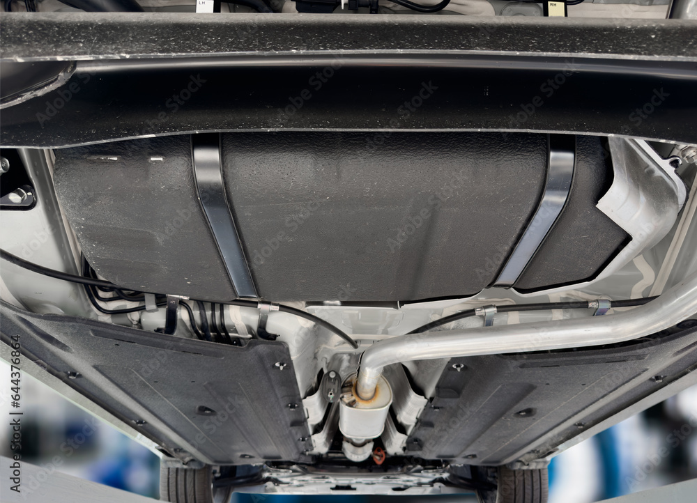 Modern car in a car service on a lift. Bottom view suspension of the ...