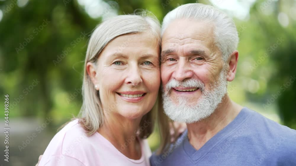 Close Up Portrait Of Married Old Senior Couple Hugging Standing In City