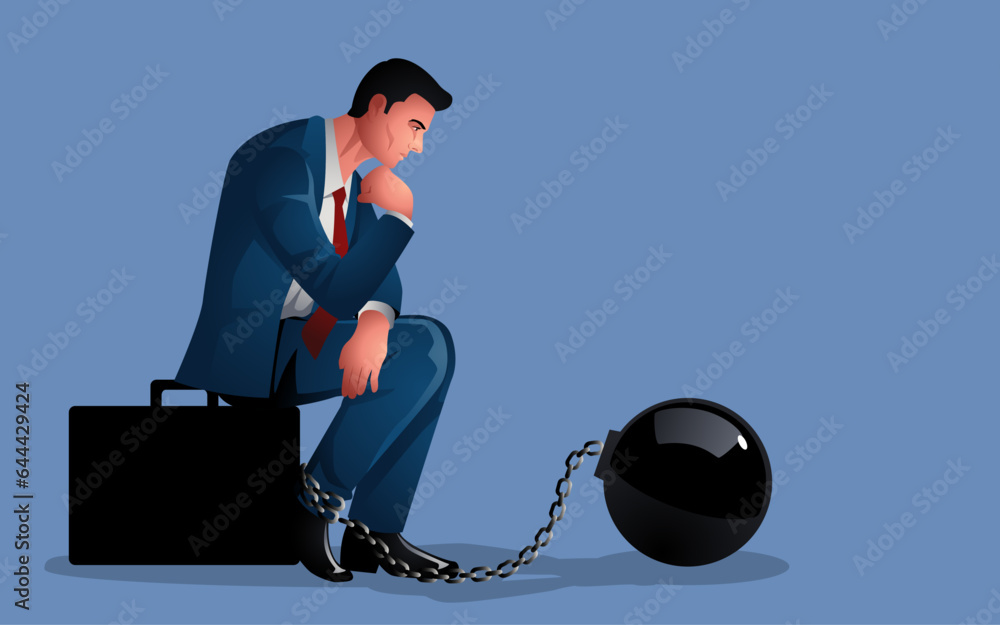 Pensive businessman seated upon a briefcase, shackled by the weight of ...