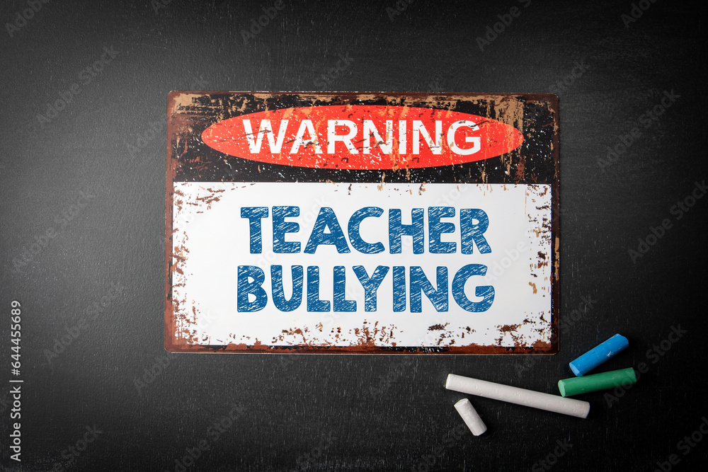Teacher Bullying. Metal warning sign and colored pieces of chalk on a ...