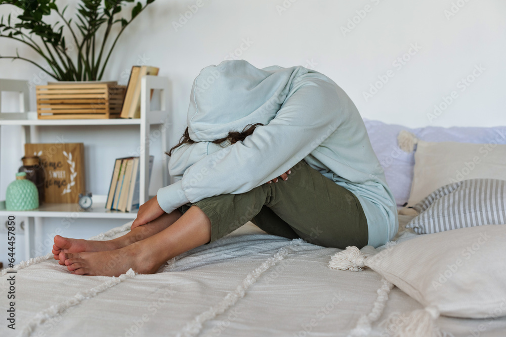 Alone teen girl upset and sad in bedroom sit on bed. Mental health ...