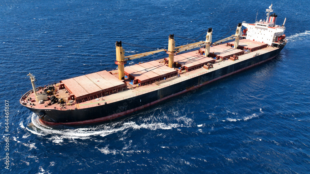 Aerial drone photo of bulk carrier ship carrying heavy merchandise and ...