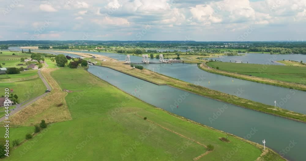 Aerial view of river Nederrijn with weir and lock complex between ...