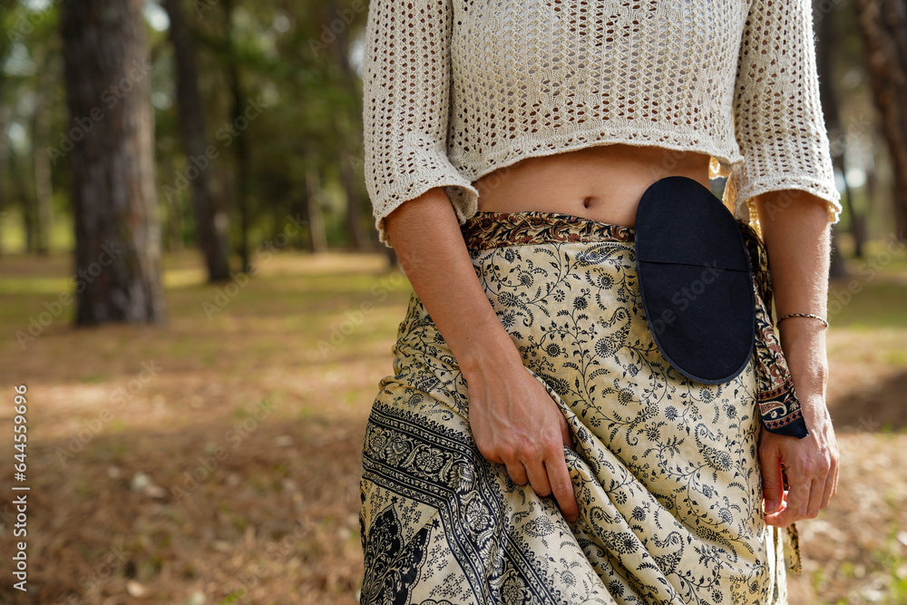 Ostomized woman lifestyle with a black ostomy bag in the nature. Colon ...
