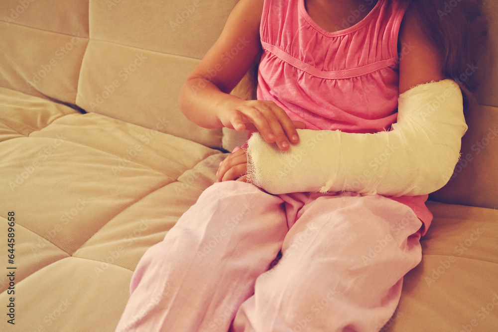 Cute little girl with a plaster cast on her arm Stock Photo | Adobe Stock