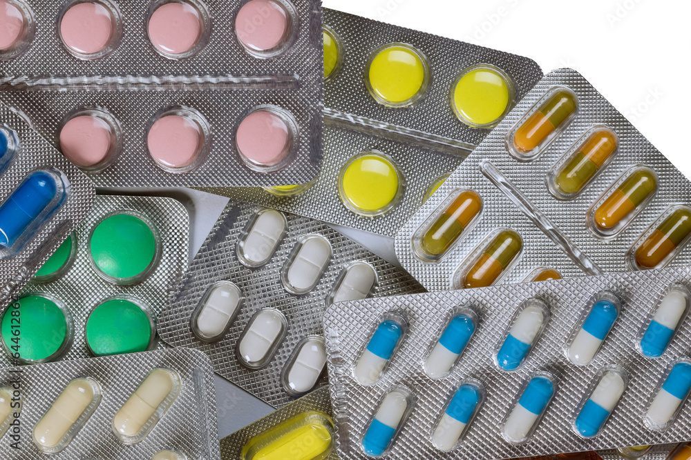 Colorful pills, tablets, capsules are arranged in various ...