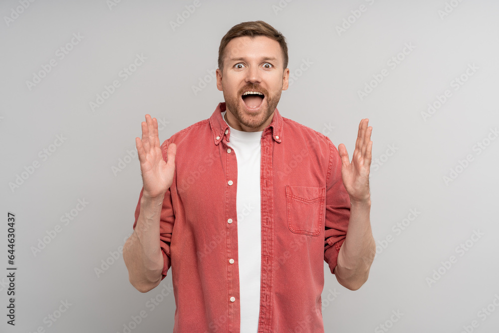 Smiling surprised man with eyes wide open feeling delight spread hands ...