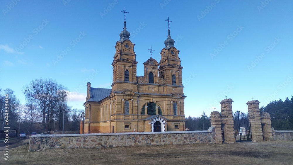 The historic brick church building with two towers, domes and crosses ...