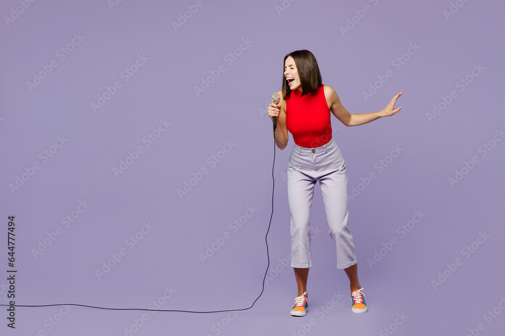 Young singer expressive woman she wearing red tank shirt casual clothes ...