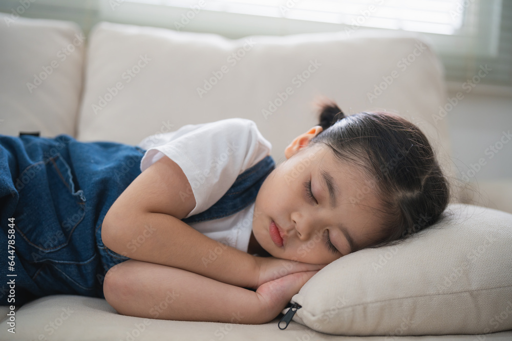 Cute little girl child sleeping on couch sofa with soft pillows at ...