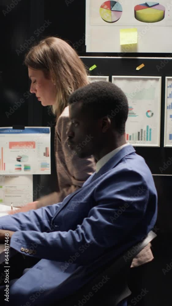 Vertical video Diverse detectives in well-organized office reviewing ...