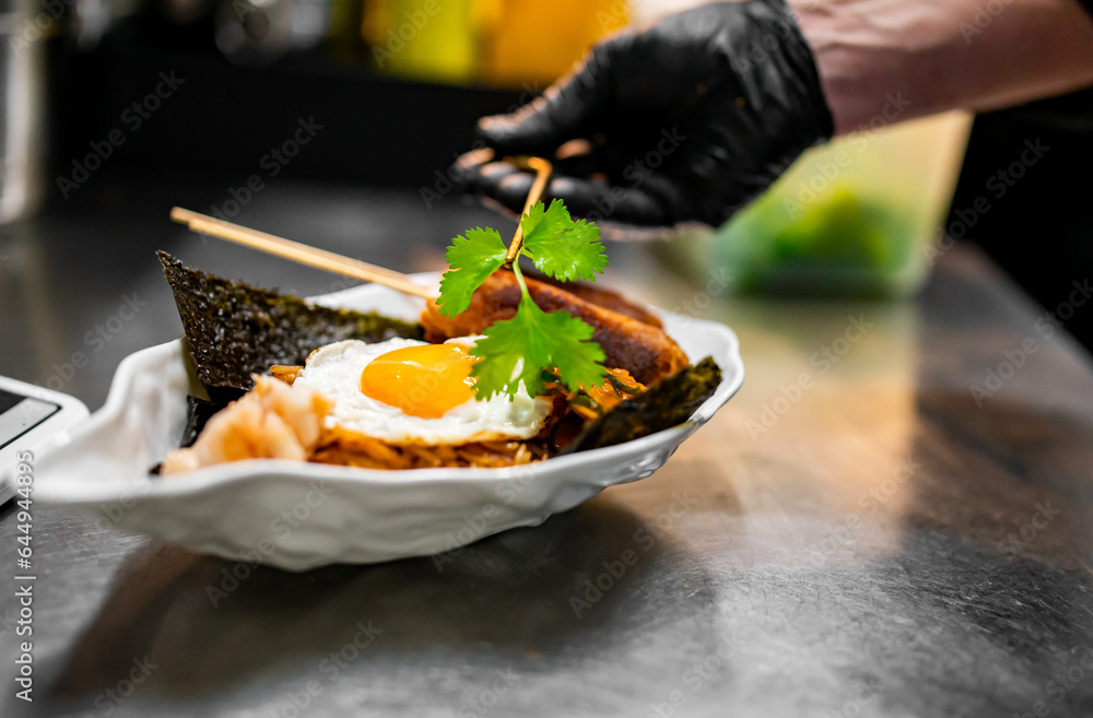 chef cooking Korean Bibimbap Rice with Egg, vegetables and Beef on ...