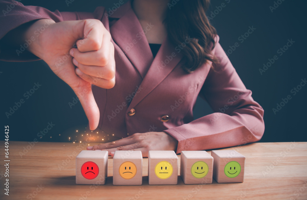 Woman's hand give a 1 star and unhappy face icon satisfaction rating ...