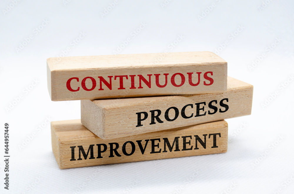 Continuous process improvement text on wooden blocks. Business culture ...