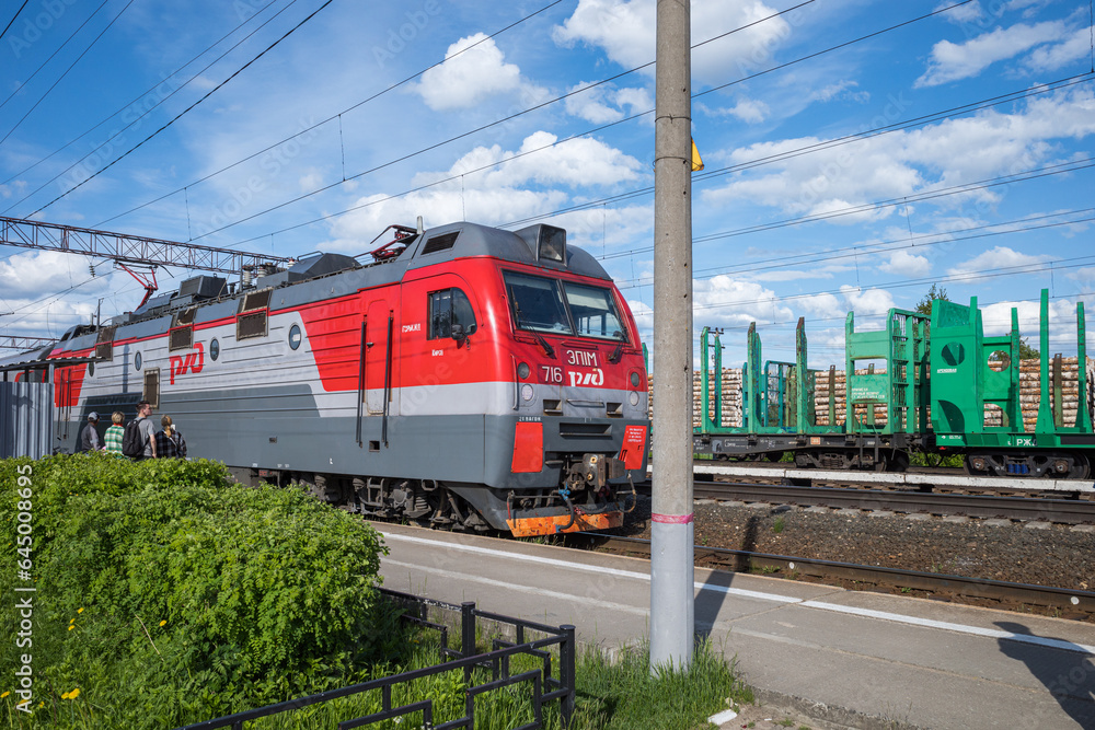 train travels by rail on a sunny day, the train with the logo of RZD ...
