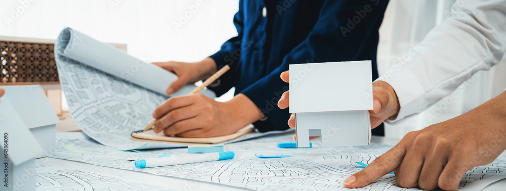 Worker, architect and engineer work on real estate construction project ...