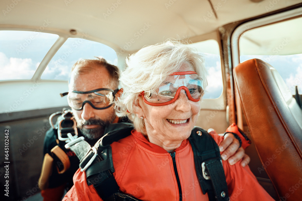 Scared senior female skydiver and her skydiving instructor getting ...