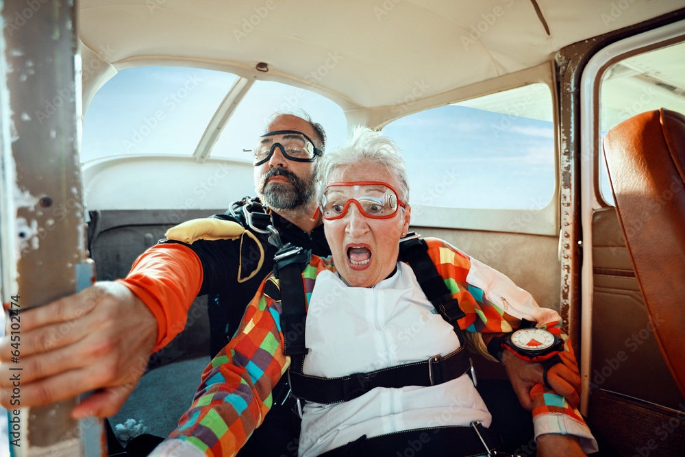 Scared senior female skydiver and her skydiving instructor getting ...