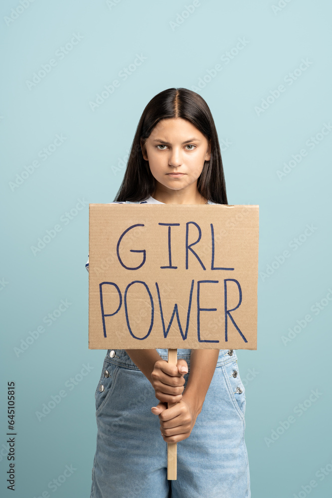 Serious confident brunette teenage girl showing holding girl power ...