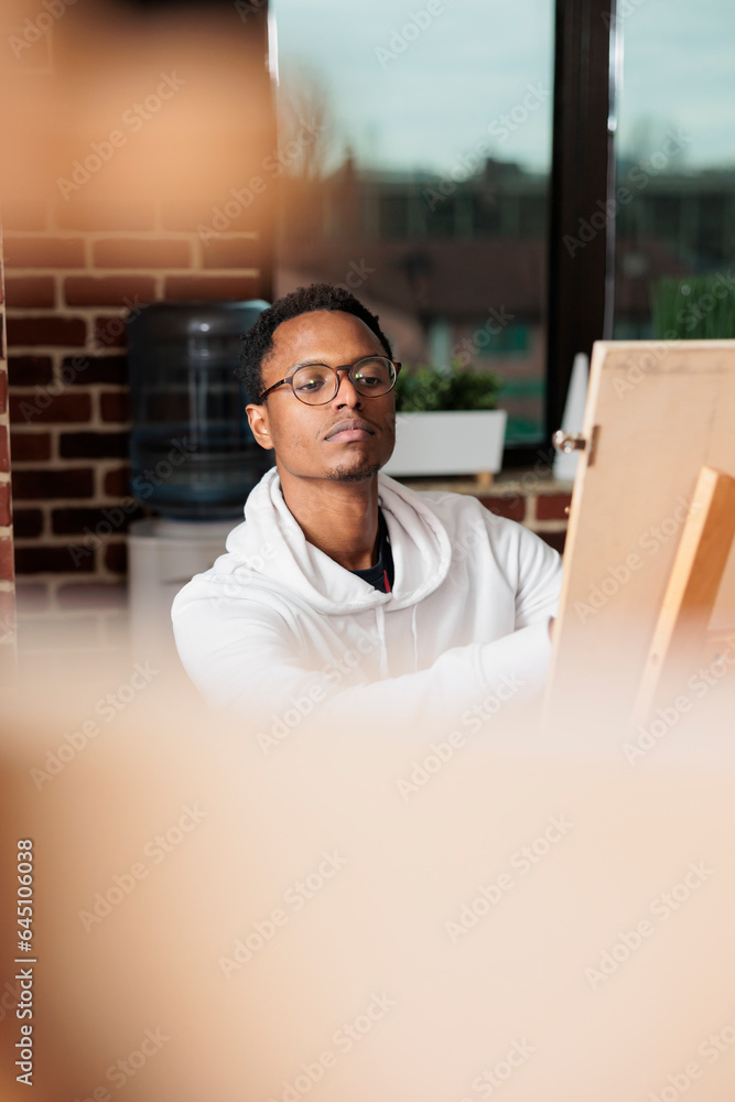 Inspired African American male student studying art at university ...