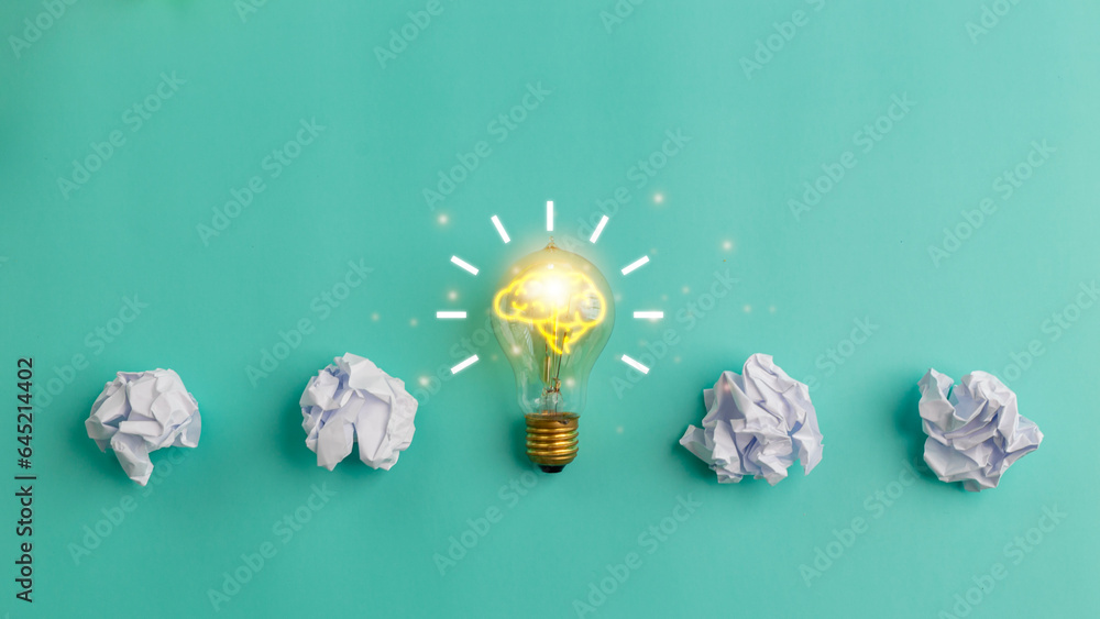Idea concept with crumpled paper and a light bulb on a blue background ...