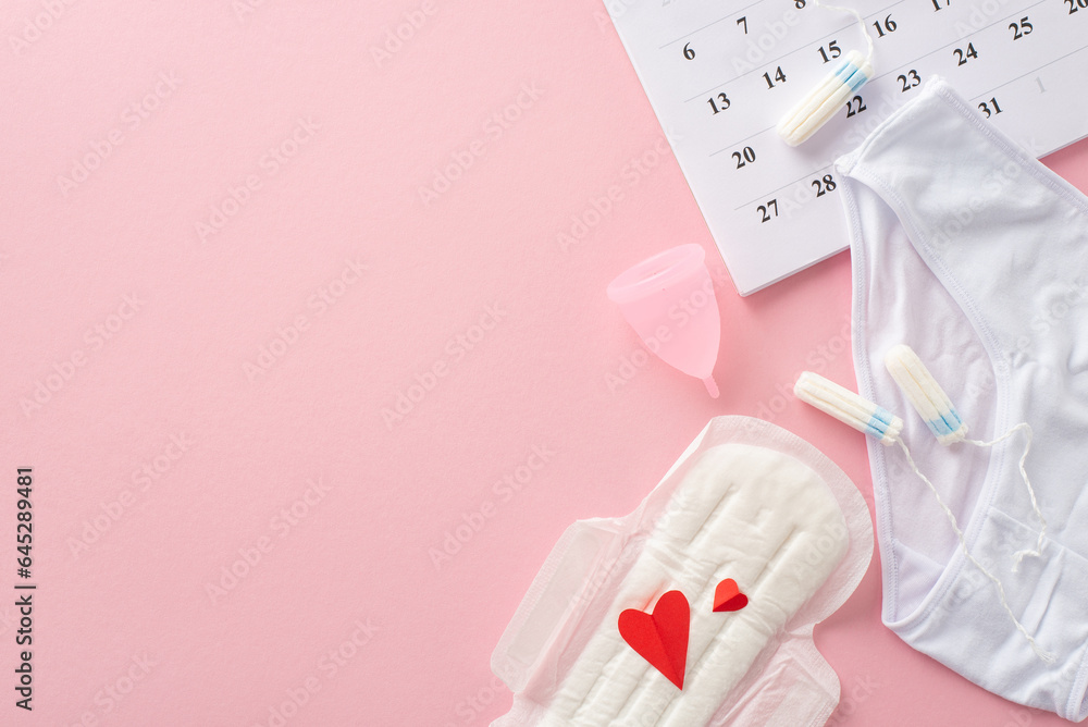 Feminine hygiene supplies like pad with red hearts, symbolizing blood ...