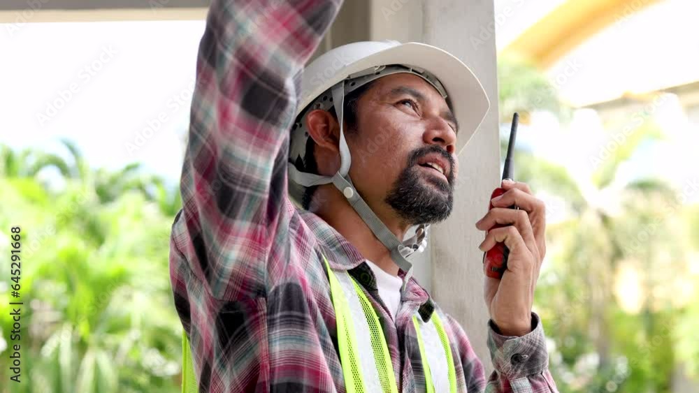 Close-up Asian contractor engineer architect foreman using walkie ...