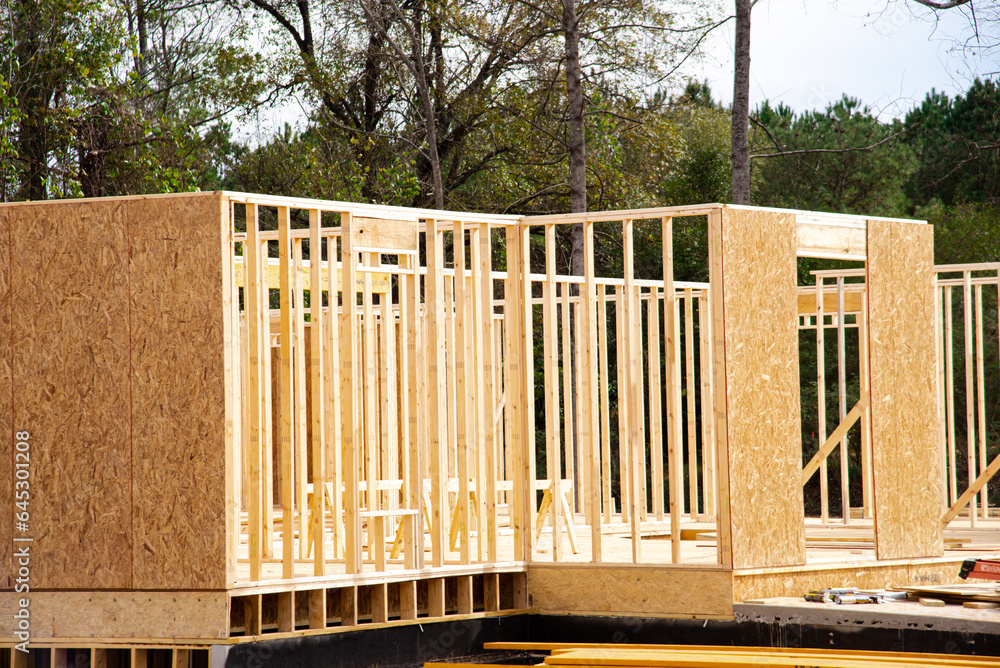Close-up post, beam and timber framing new suburban wooden house with ...