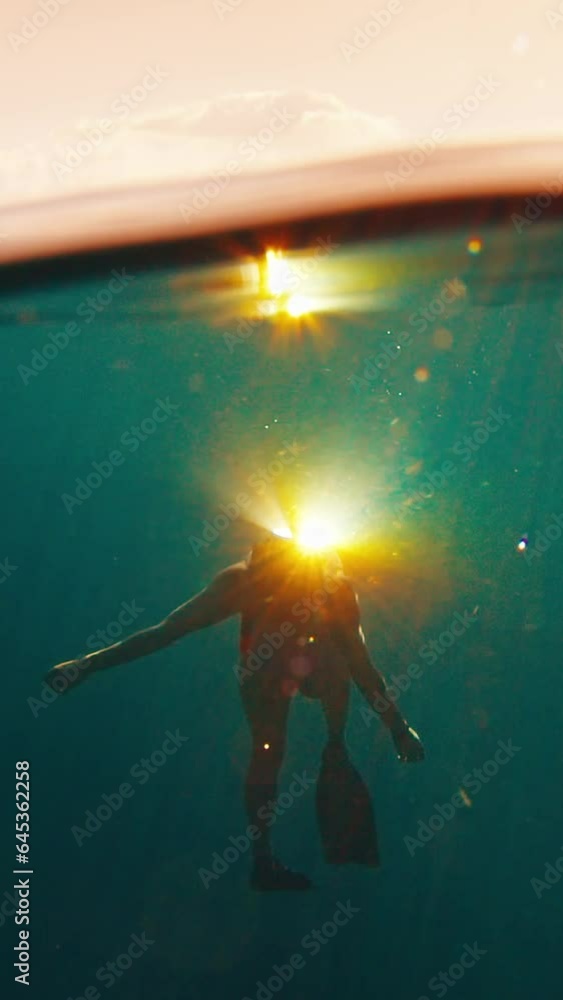 Cinemagraph of the freediver. Woman free diver floats beneath the ...