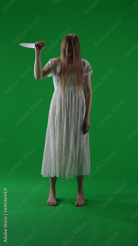 Full-size vertical green screen, chroma key shot of a posessed female ...