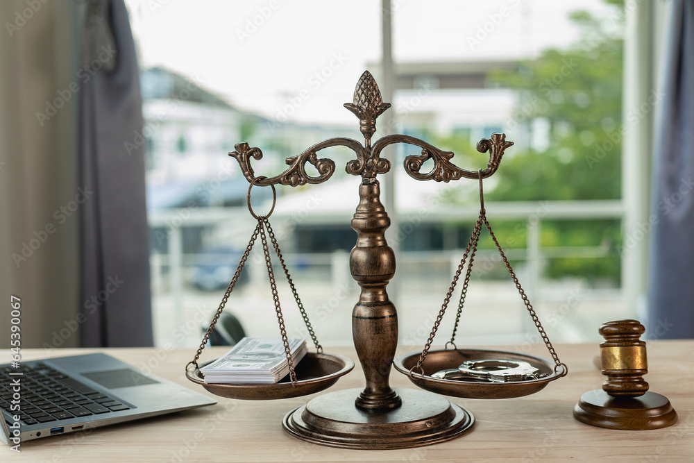 Handcuffs and dollars, scales of justice and judge's hammer on table ...
