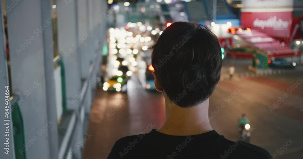 Urban scene, rear view 30s male looking at night city. Back view young ...