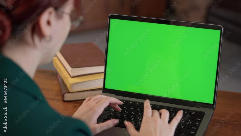 Girl Typing on Keyboard Of Laptop with Green Mock-up Screen. Female ...
