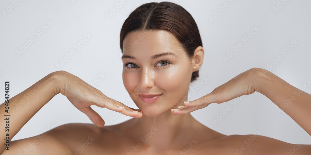 Happy beautiful young adult woman touching her perfect face with ...