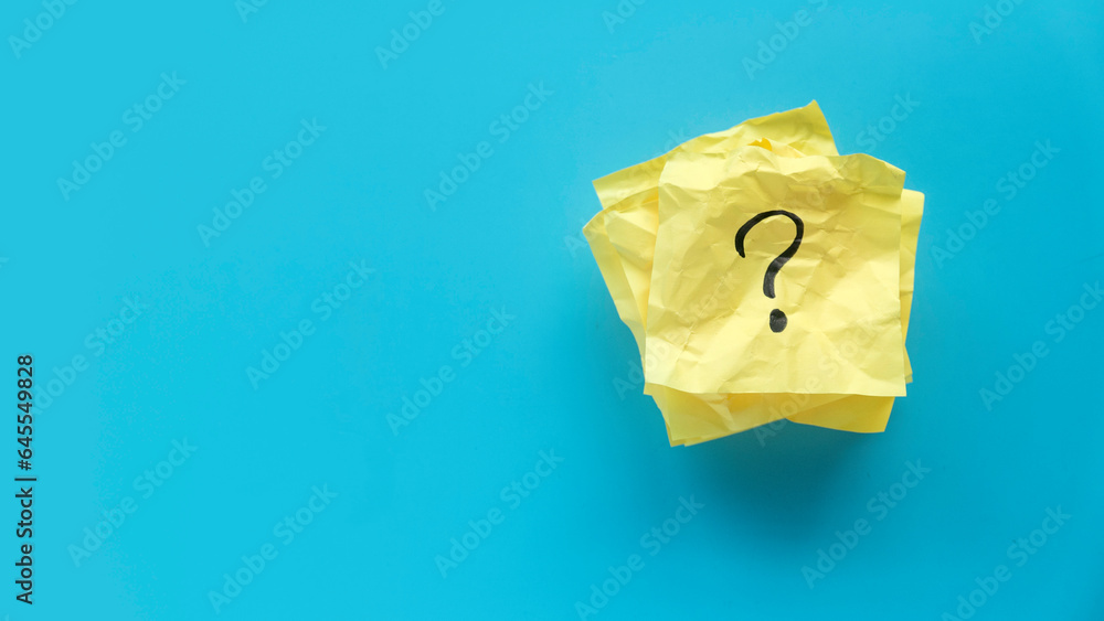 Questions and answers concept QnA. Yellow and crumpled memo note ...