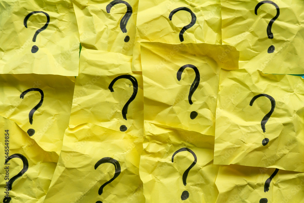 Questions and answers concept QnA. Yellow and crumpled memo note ...