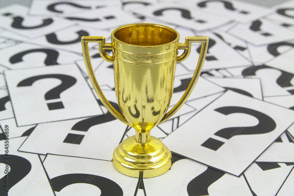 Champion trophy cup on question marks background. Sport and competition ...