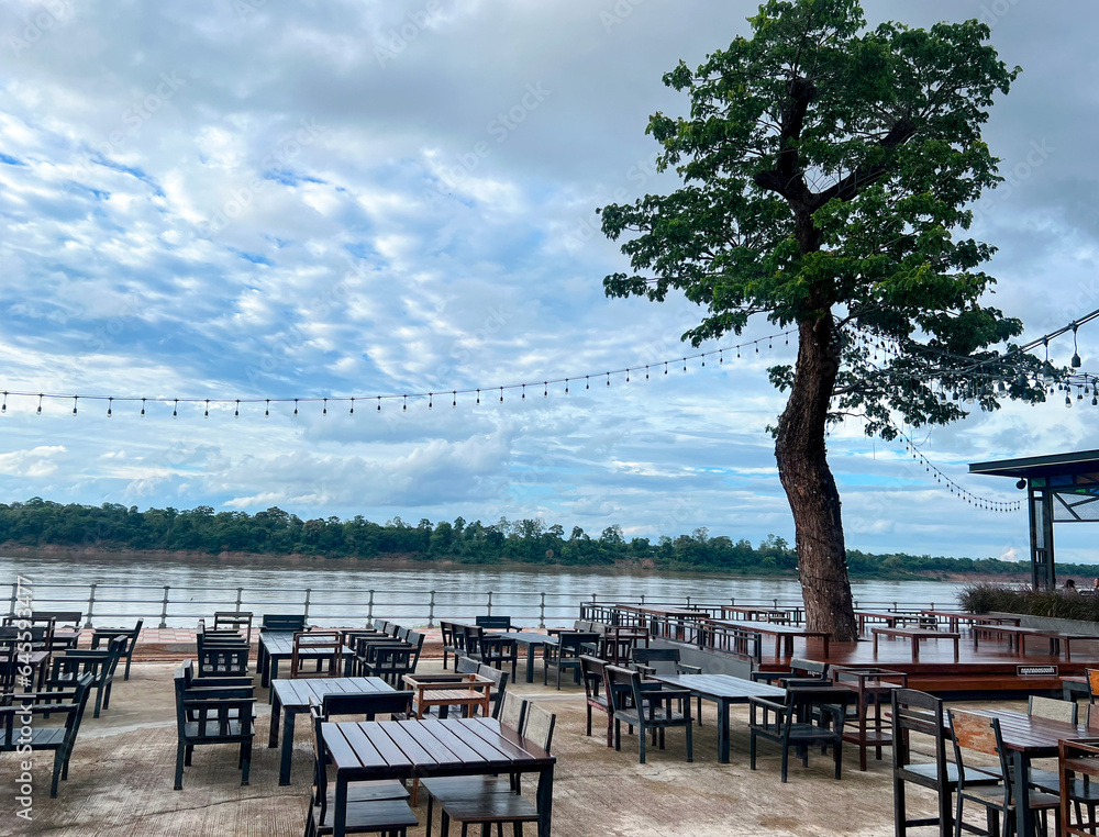 Dining table at river and trees. Outside dining or lunch concept ...