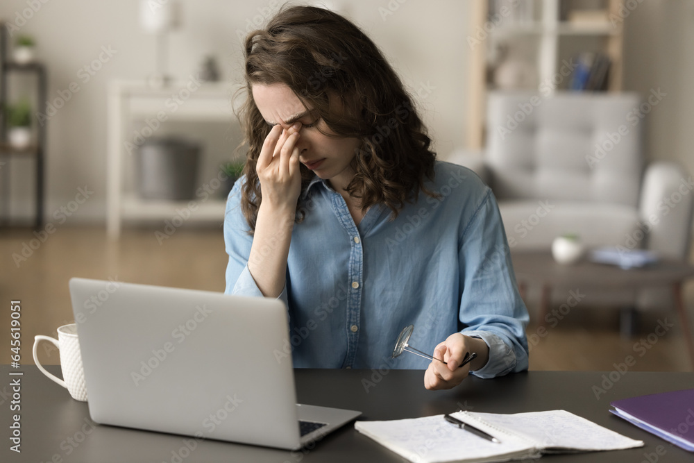 Tired frustrated freelance employee girl working at laptop, taking ...