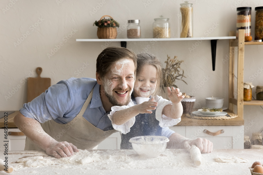 Joyful toddler kid and daddy enjoying funny baking activity with happy ...