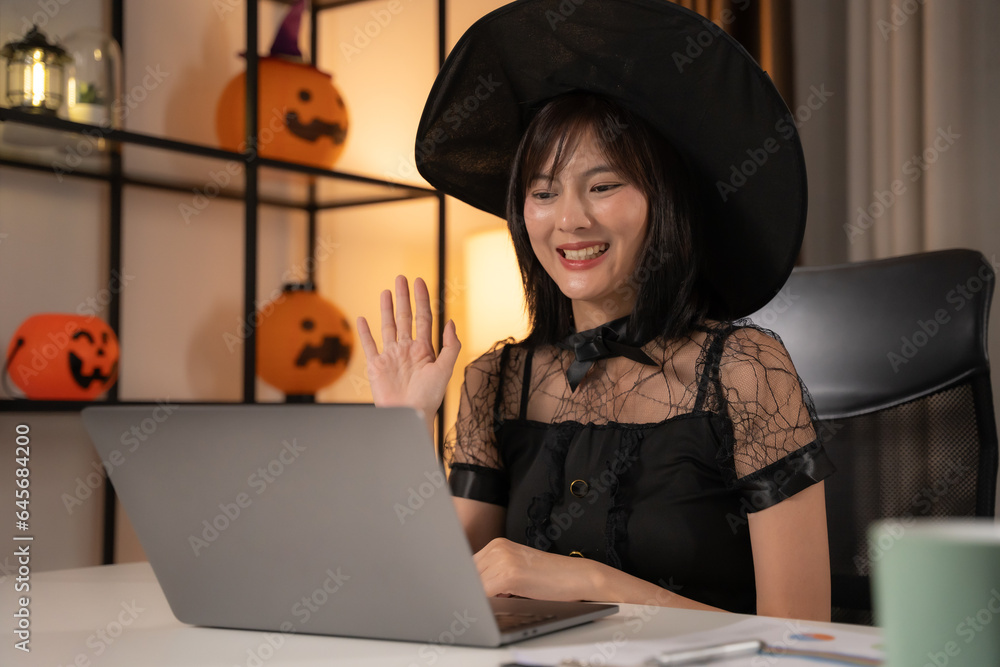 Female influencer wearing witch costume and live streaming at home. She ...