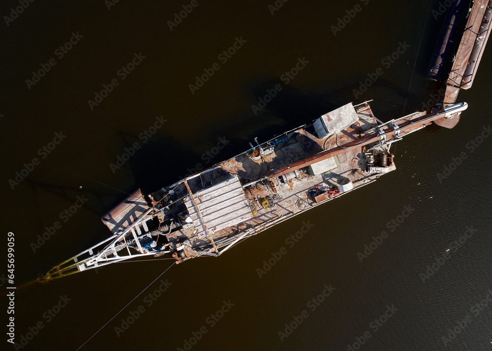 Trailing suction hopper dredger draws up bottom mud on river Stock ...