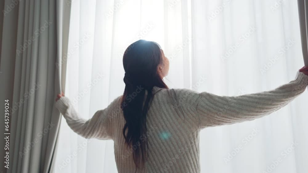 Smiling Asian woman opening curtains at morning, Hands pulling window ...