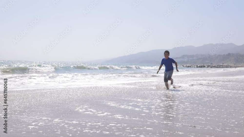 12 year old boy running on the beach in Santa Monica. Slow Motion ...